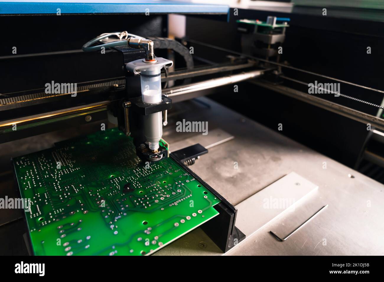 Machine working on surface of PCB printed circuit board putting on ...