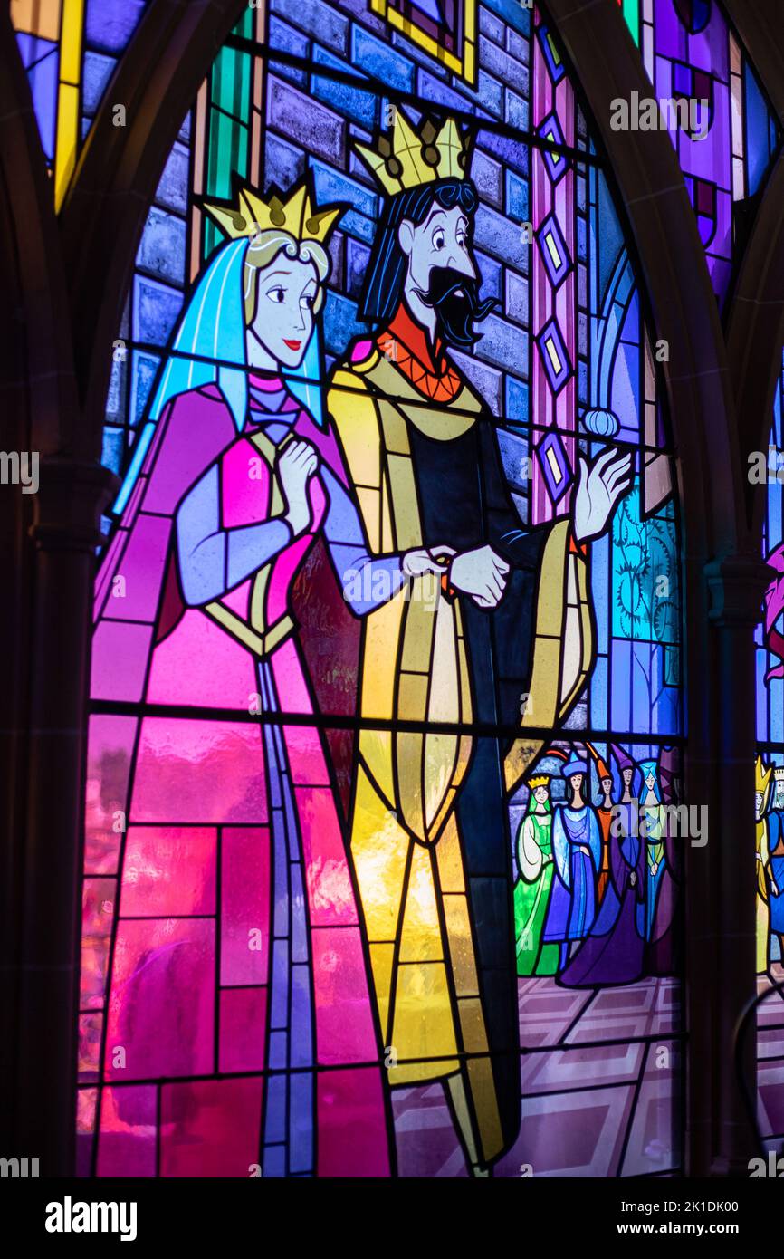 A vertical shot of a colorful stained glass with Disney cartoon ...
