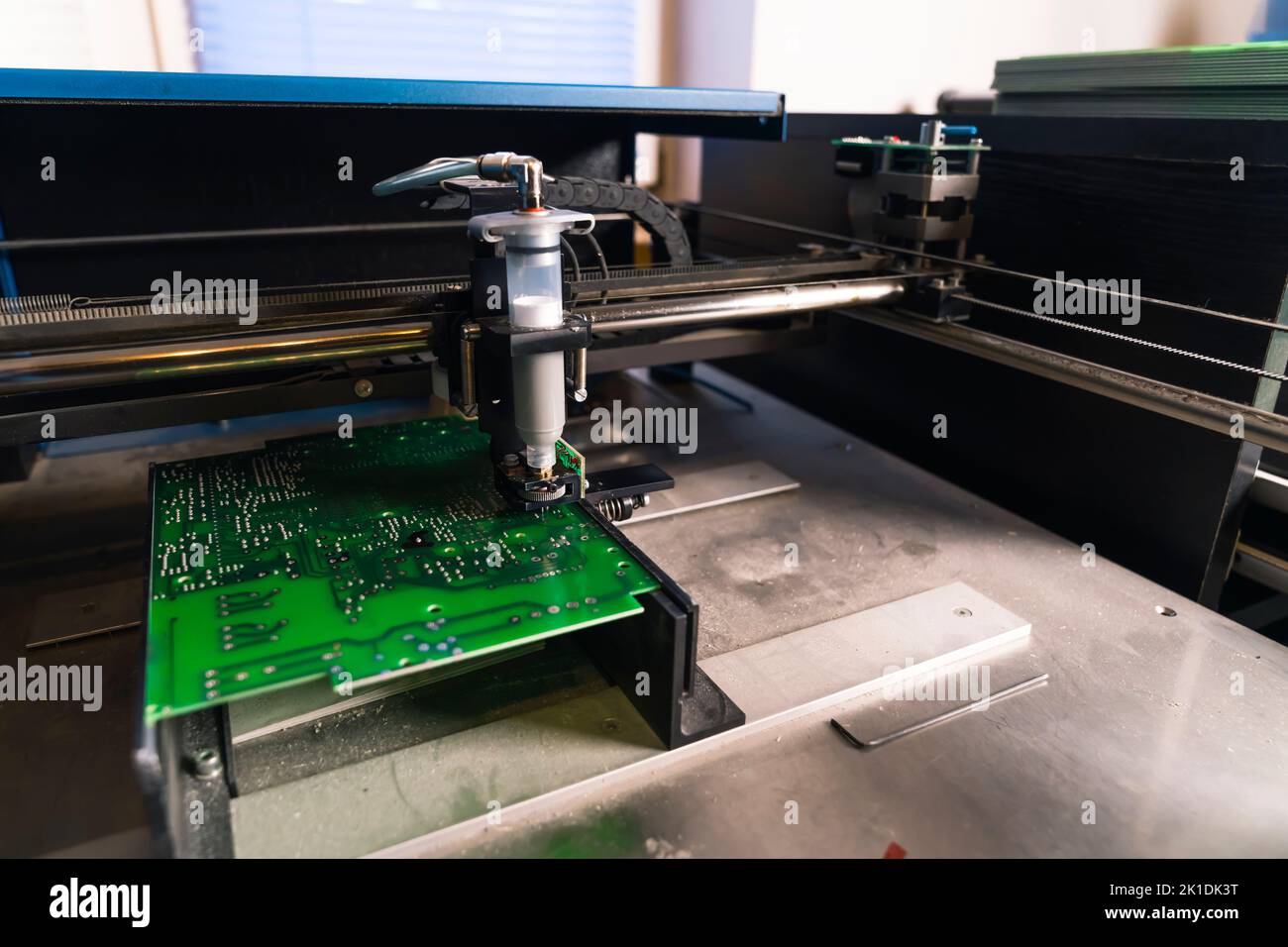 Machine distributing solder onto surface of printed circuit board PCB ...
