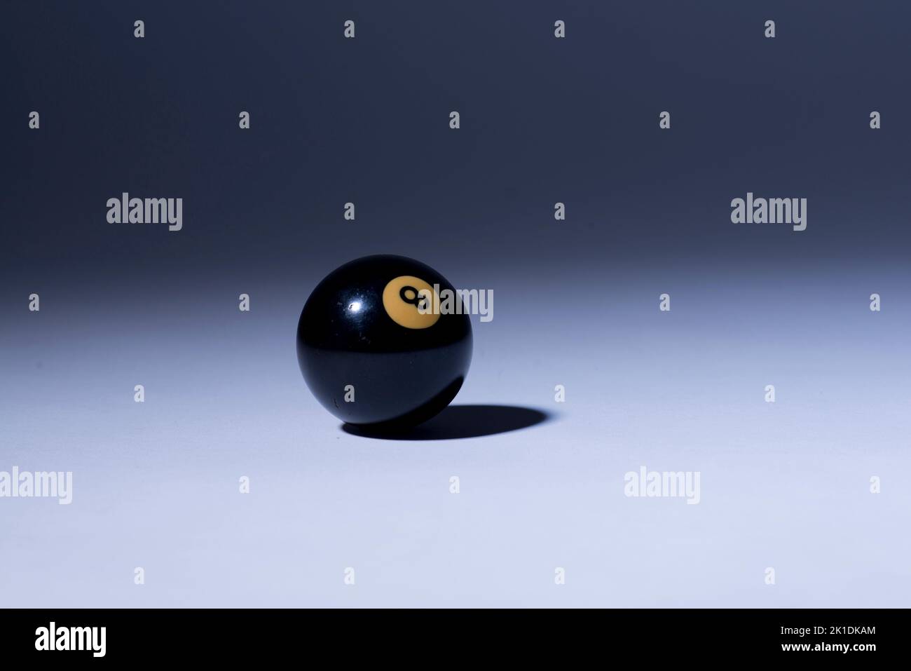Eight ball symbol for success closeup on eightball with light ...