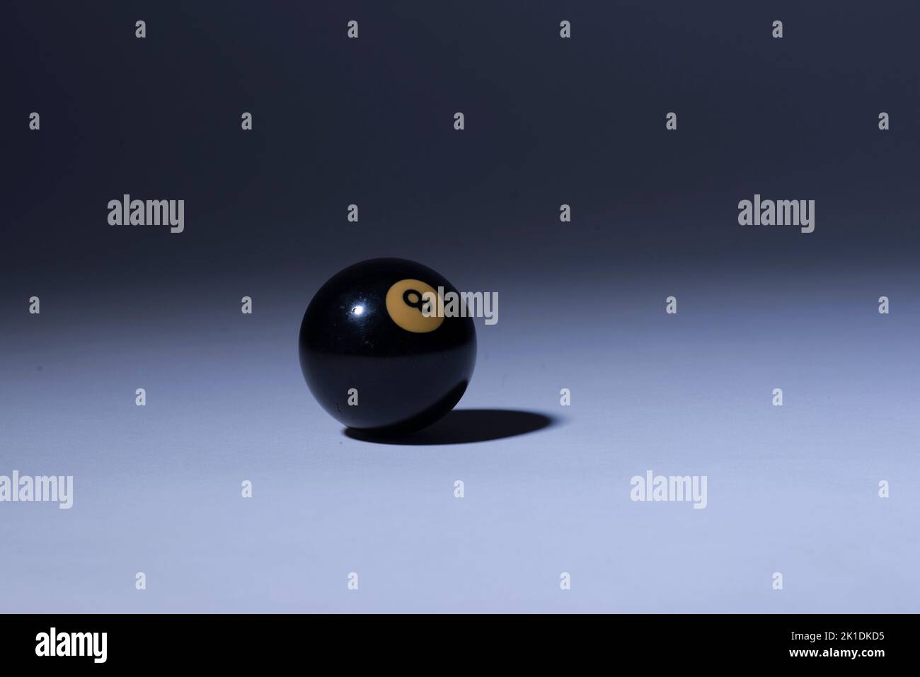 Eight ball symbol for success closeup on eightball with light ...