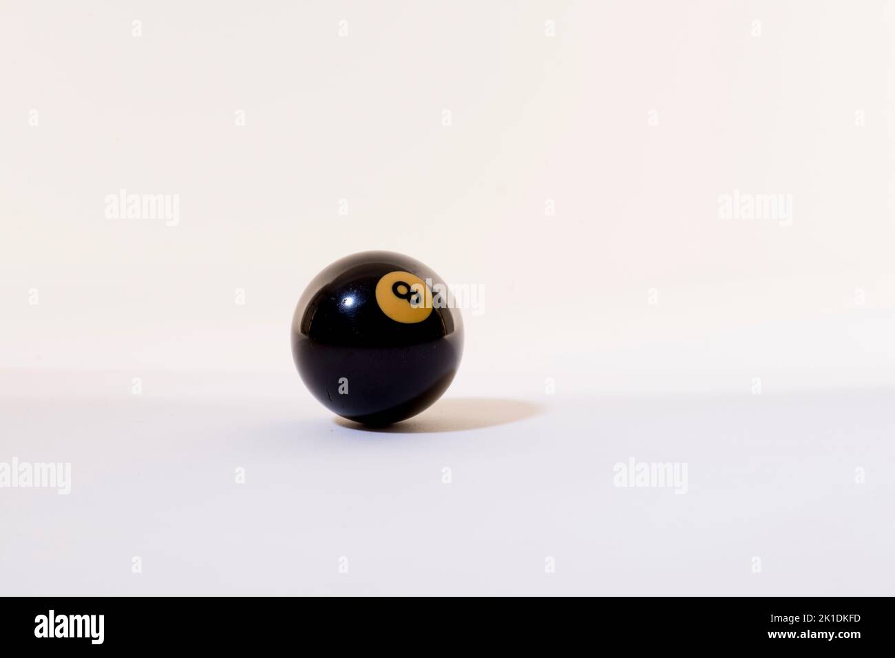 Eight ball symbol for success closeup on eightball with light ...