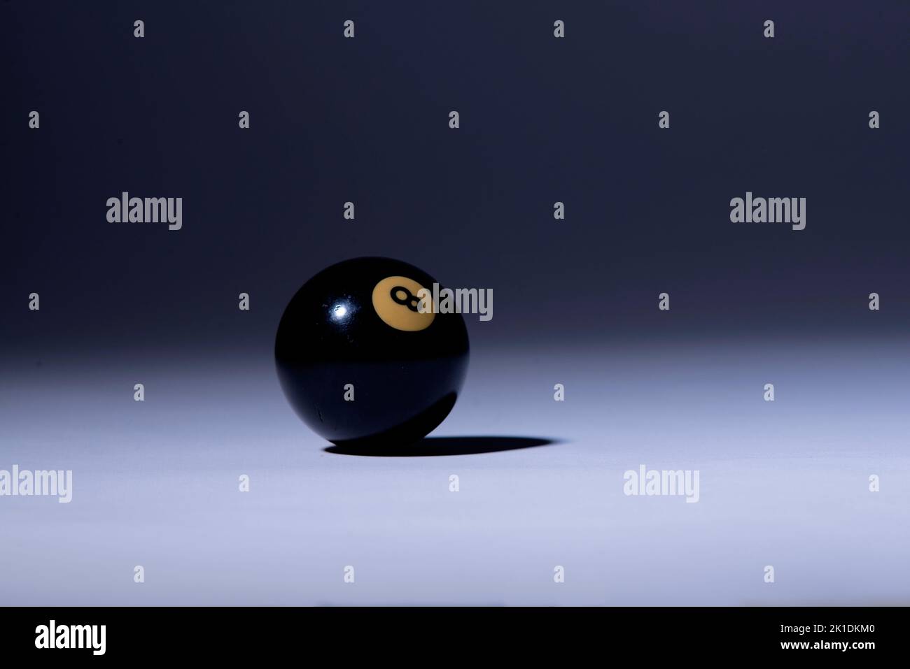 Eight ball symbol for success closeup on eightball with light ...