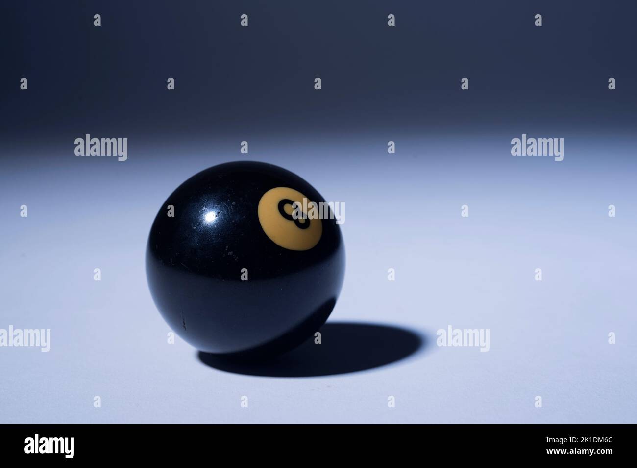 Eight ball symbol for success closeup on eightball with light ...