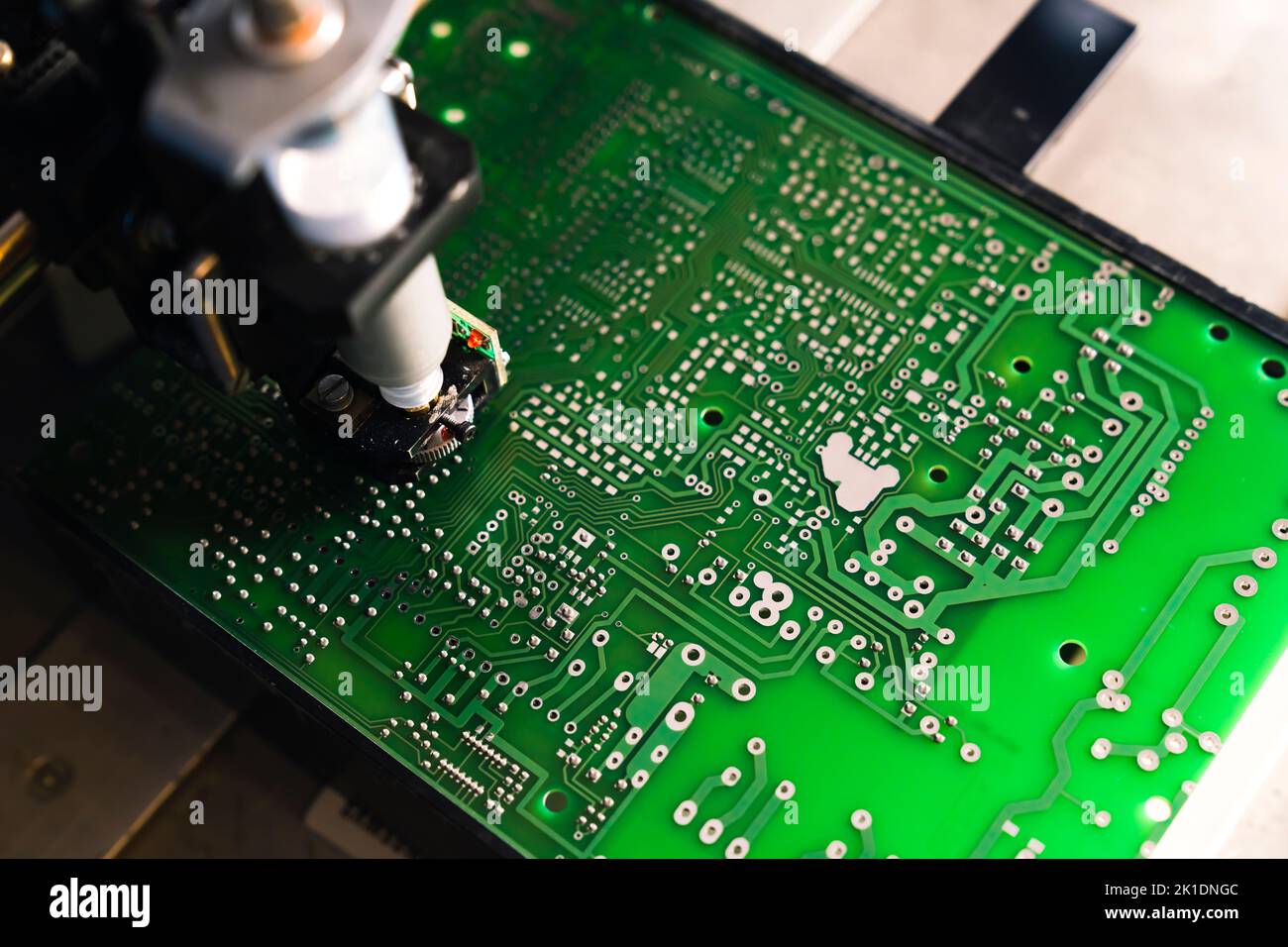 Close up of soldering process. Dispenser machine putting solder onto ...