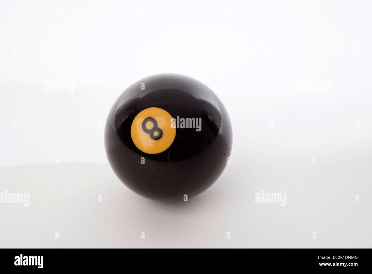 Eight ball symbol for success closeup on eightball with light ...