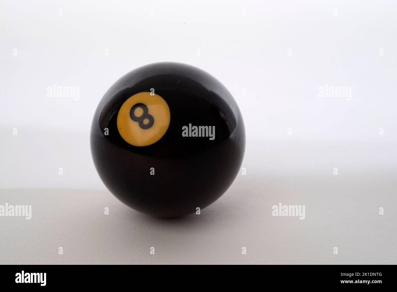 Eight ball symbol for success closeup on eightball with light ...