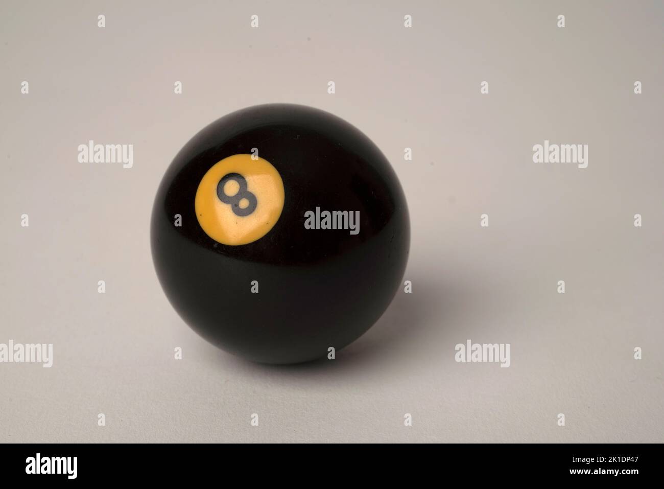 Eight ball symbol for success closeup on eightball with light ...