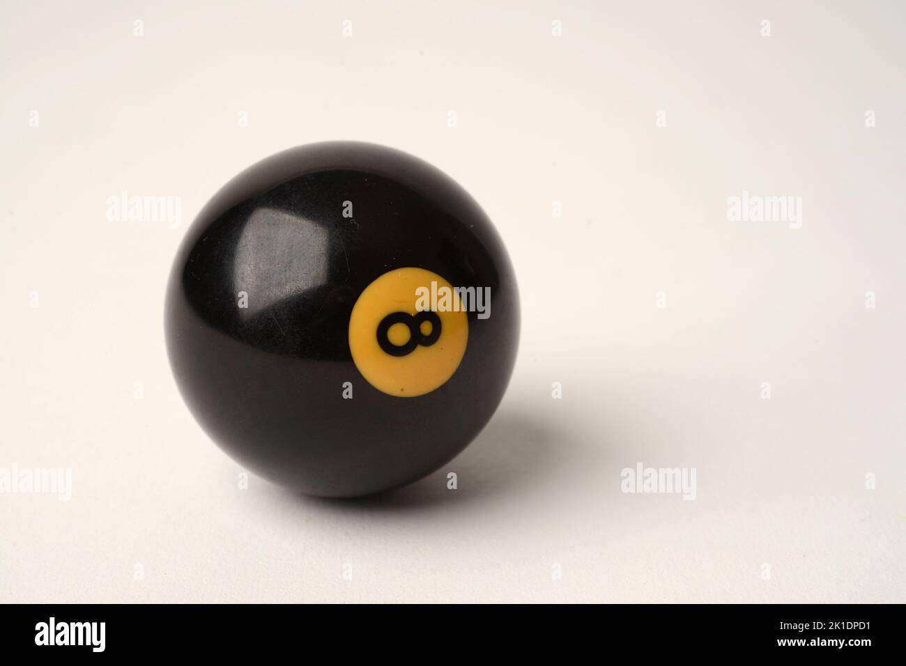 Eight ball symbol for success closeup on eightball with light ...