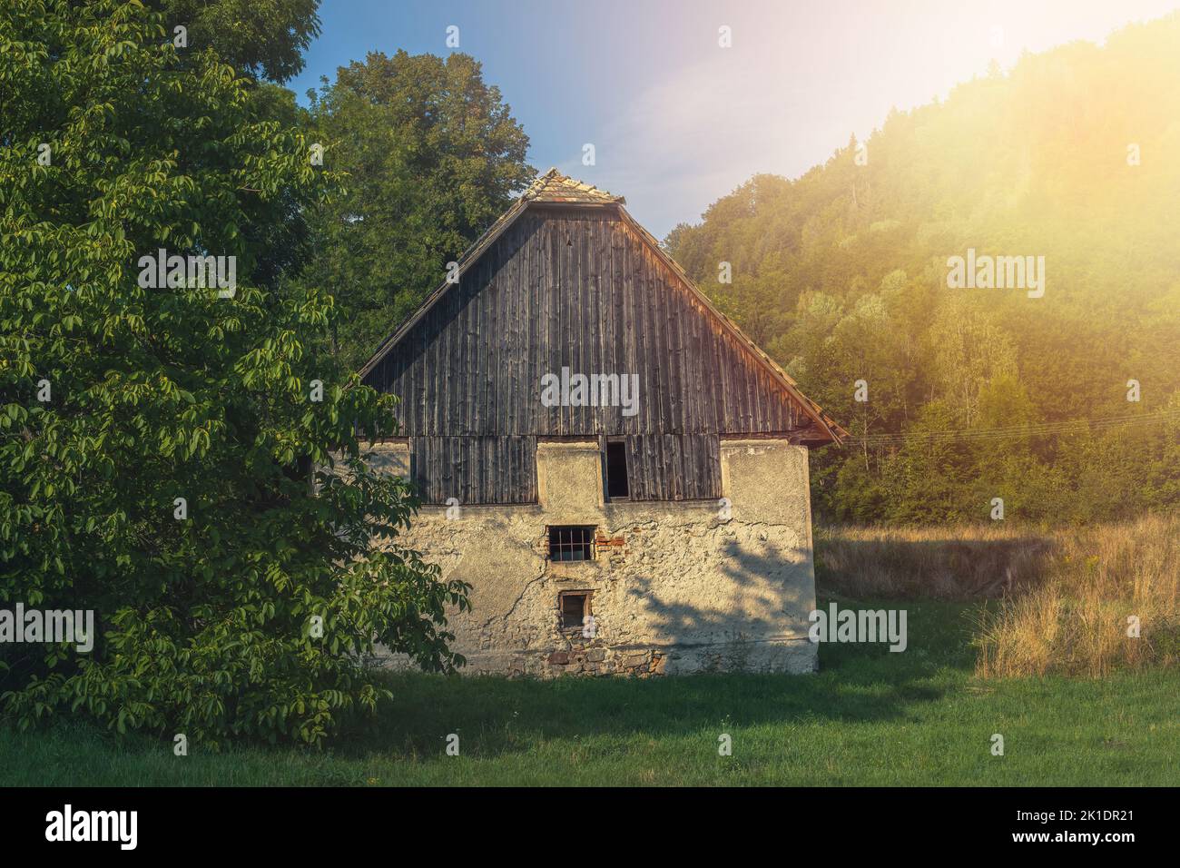 Old barn in beautiful natural surroundings during the evening sun ...