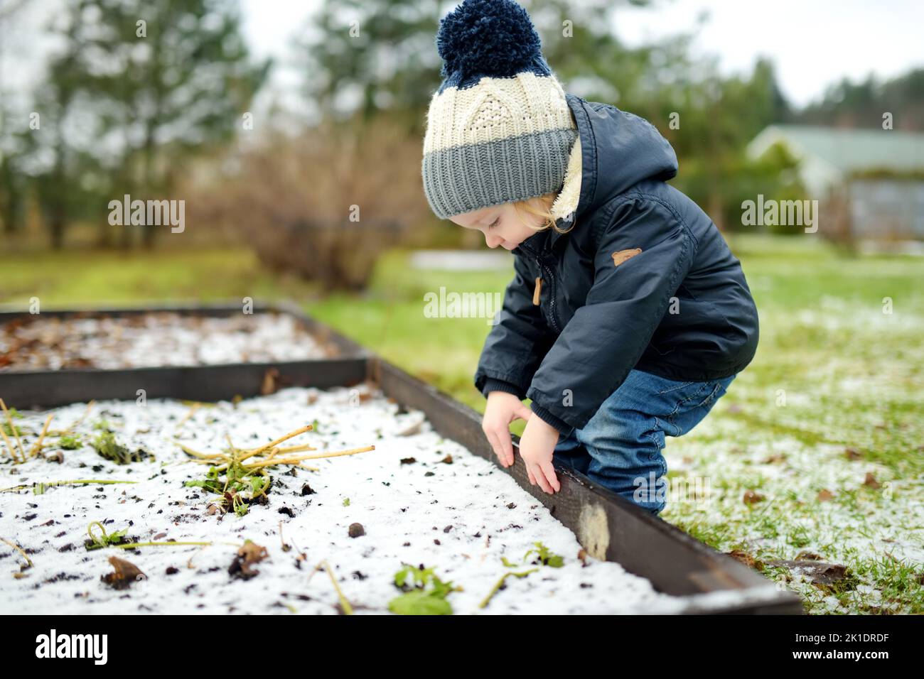 Funny toddler boy having fun outdoors on chilly winter day. Child ...