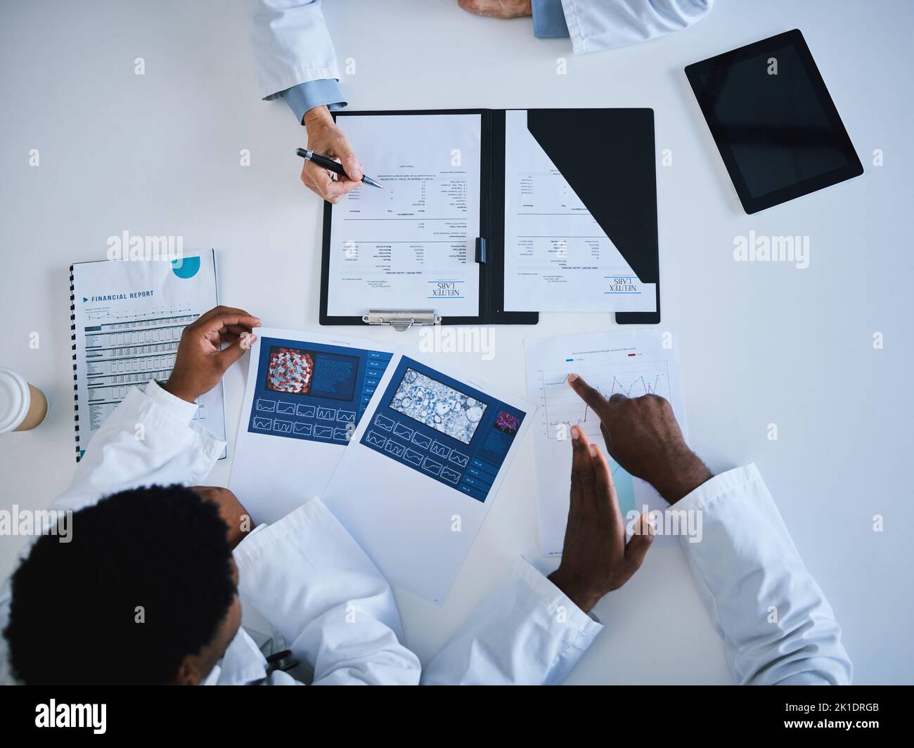 Doctor, research paper and finance planning in meeting, collaboration or teamwork strategy with ...