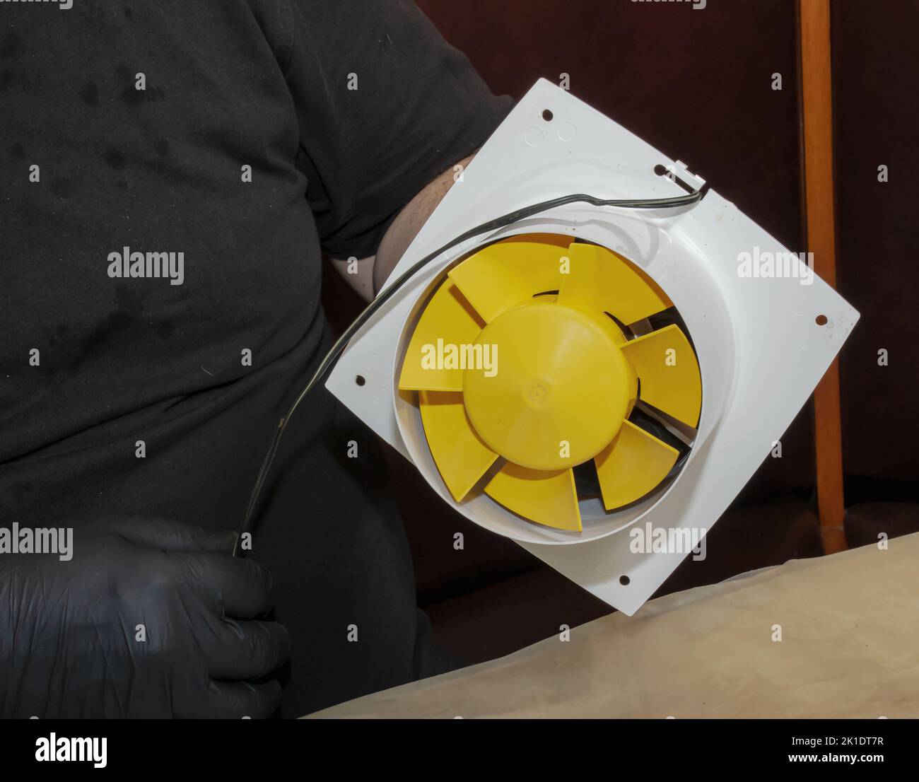 The process of assembling the kitchen exhaust fan after cleaning the ...
