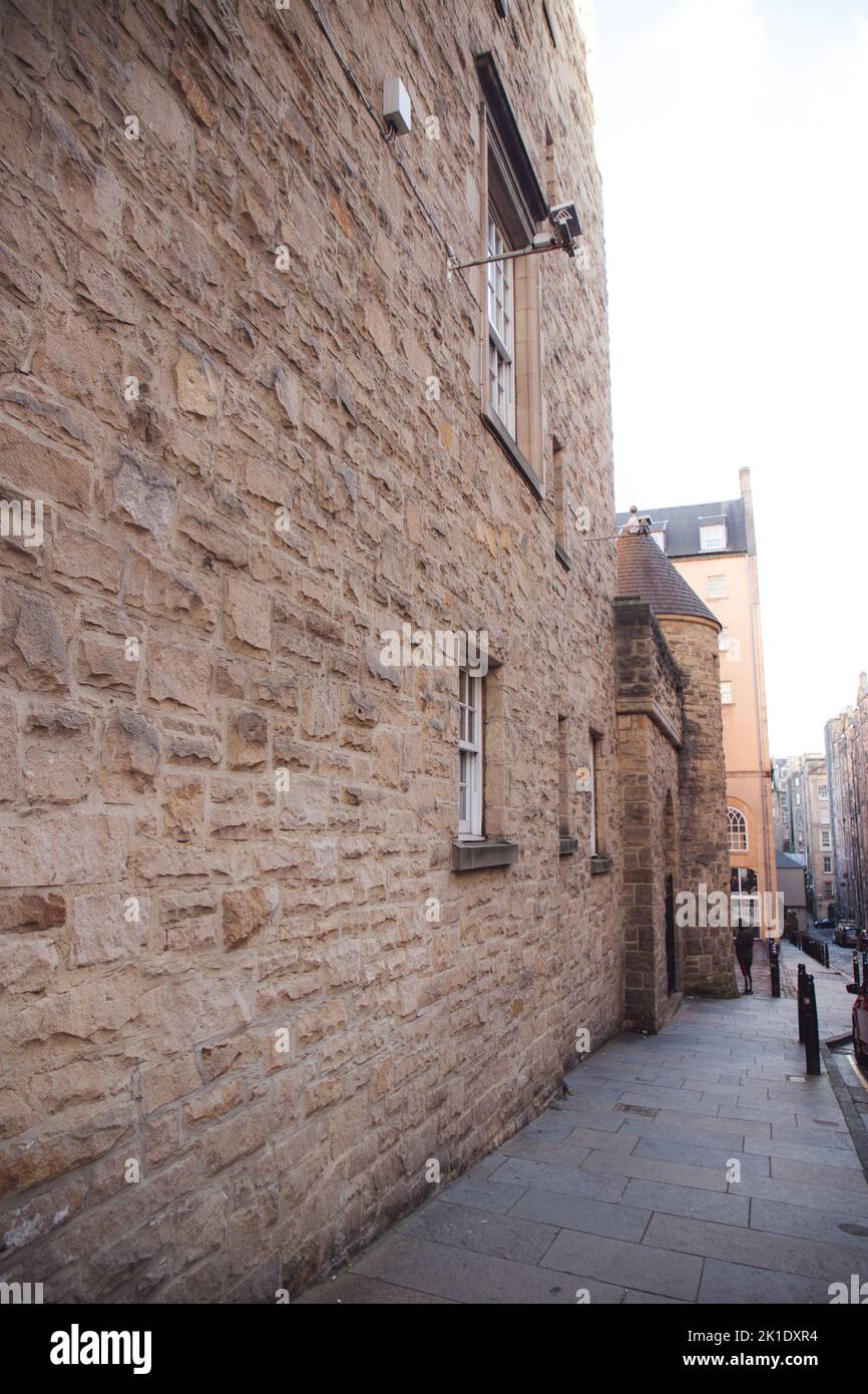 A vertical shot of a narrow alleyway between traditional stone ...