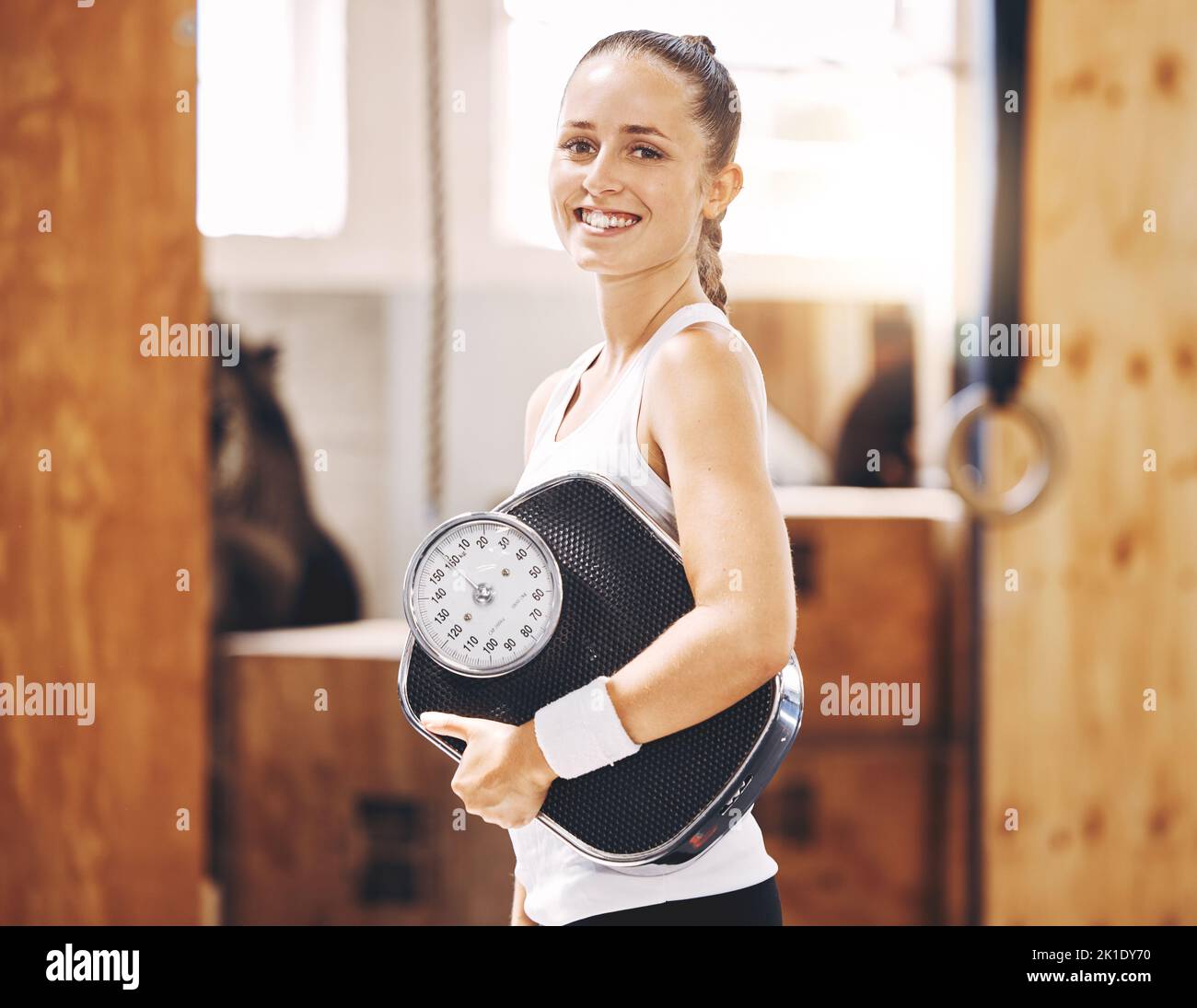 Fitness woman with weightloss scale in gym, sports studio and exercise ...