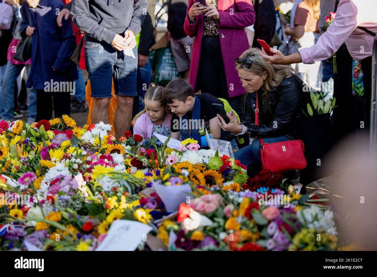 Children seen reading the message cards at the floral tributes area ...