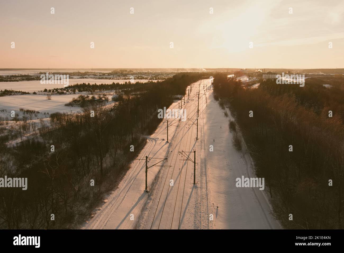 Aerial view of a railroad among pine forests at winter. Winter scenery ...