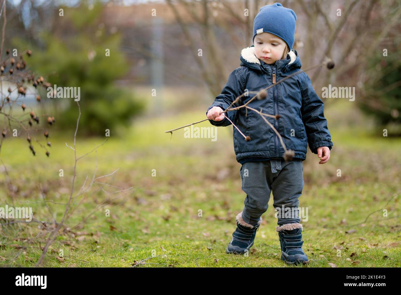 Funny toddler boy having fun outdoors on chilly winter day. Child ...