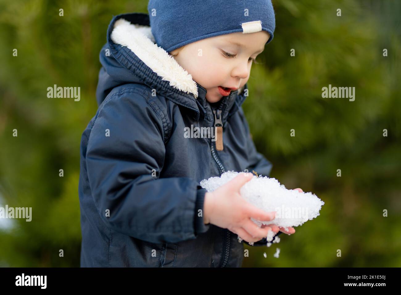 Funny toddler boy having fun outdoors on chilly winter day. Child ...