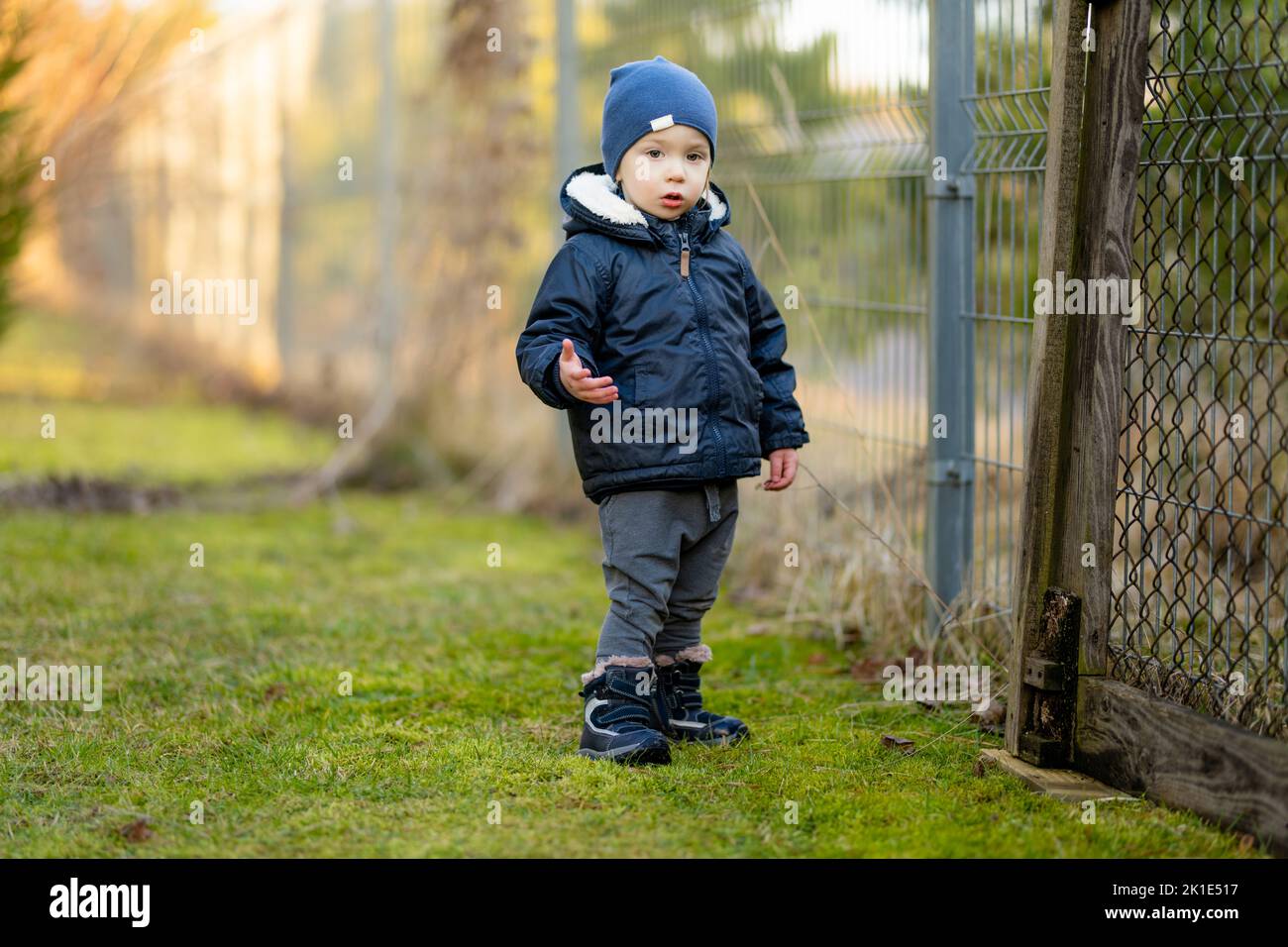 Funny toddler boy having fun outdoors on chilly winter day. Child ...