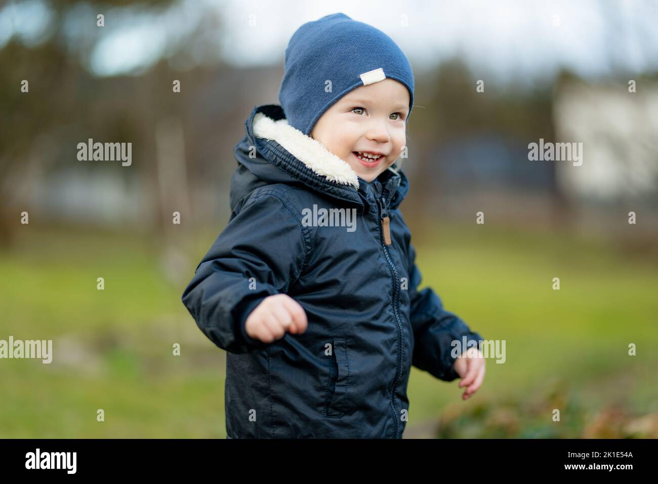 Funny toddler boy having fun outdoors on chilly winter day. Child ...