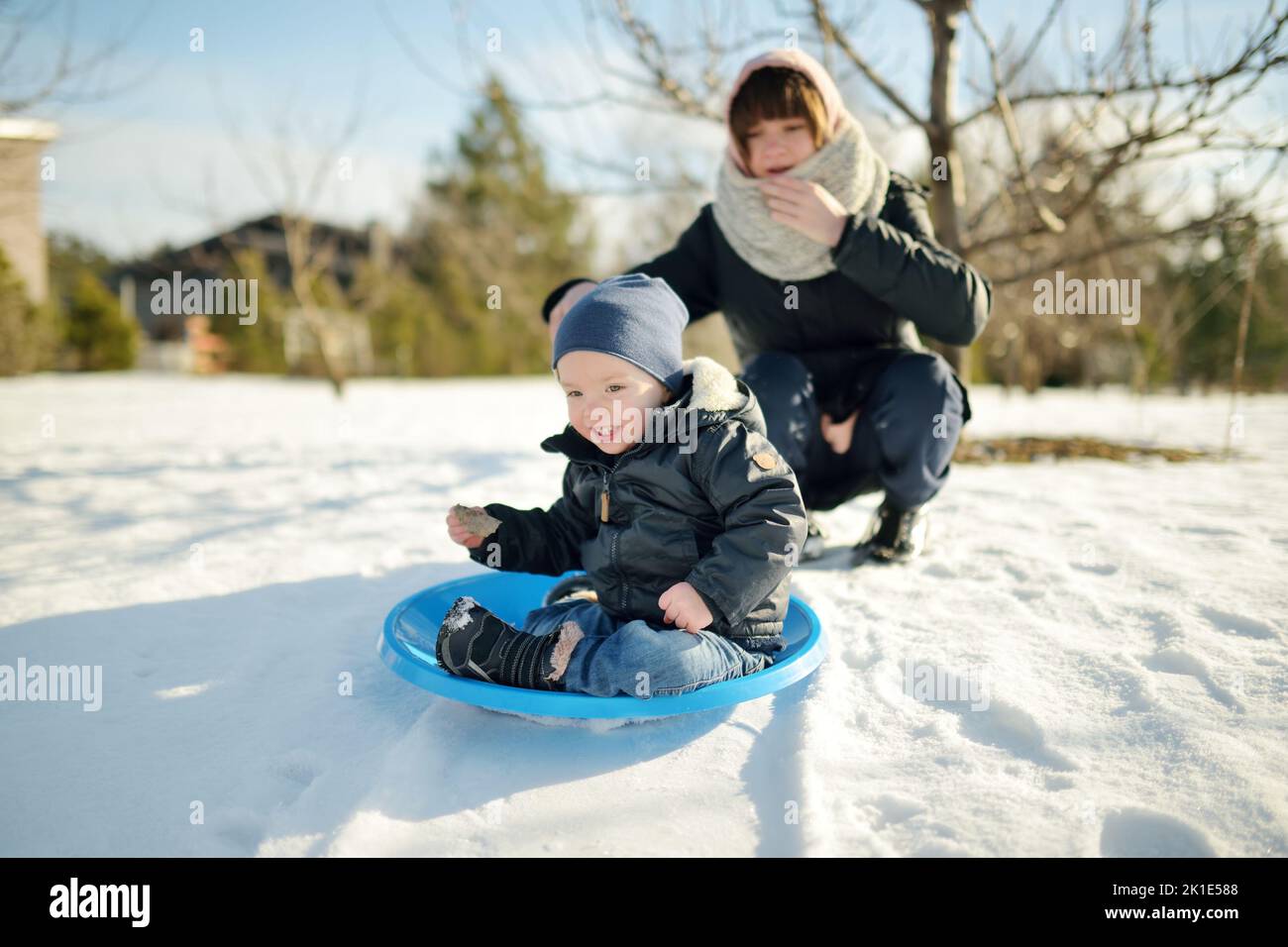 Funny toddler boy and his big teenage sister having fun outdoors on ...