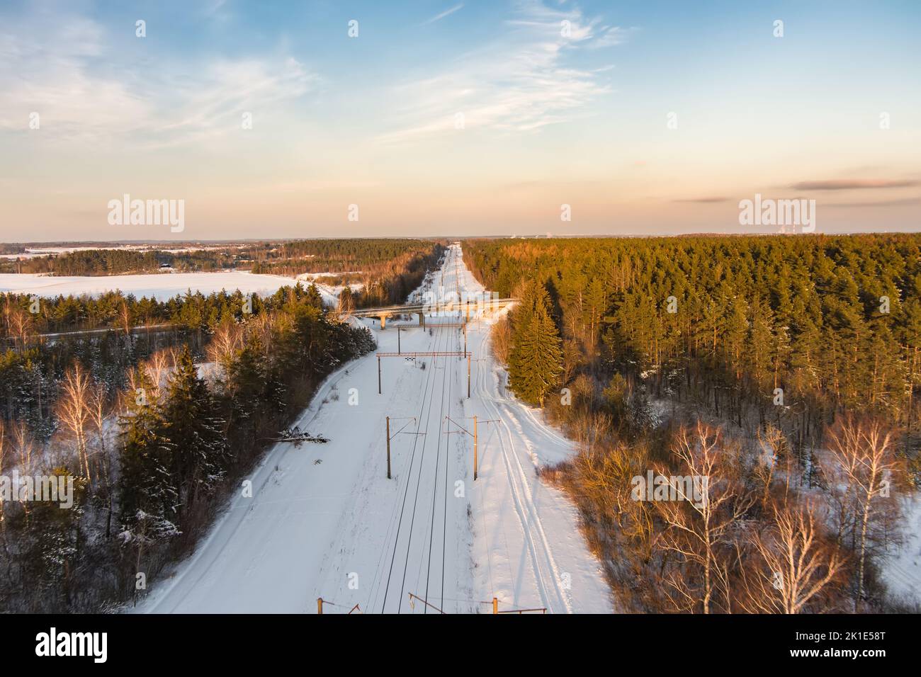 Aerial view of a railroad among pine forests at winter. Winter scenery ...
