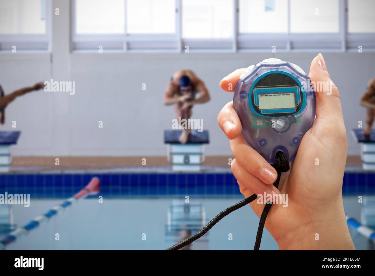 Close up of woman is holding a stopwatch on a white background against ...