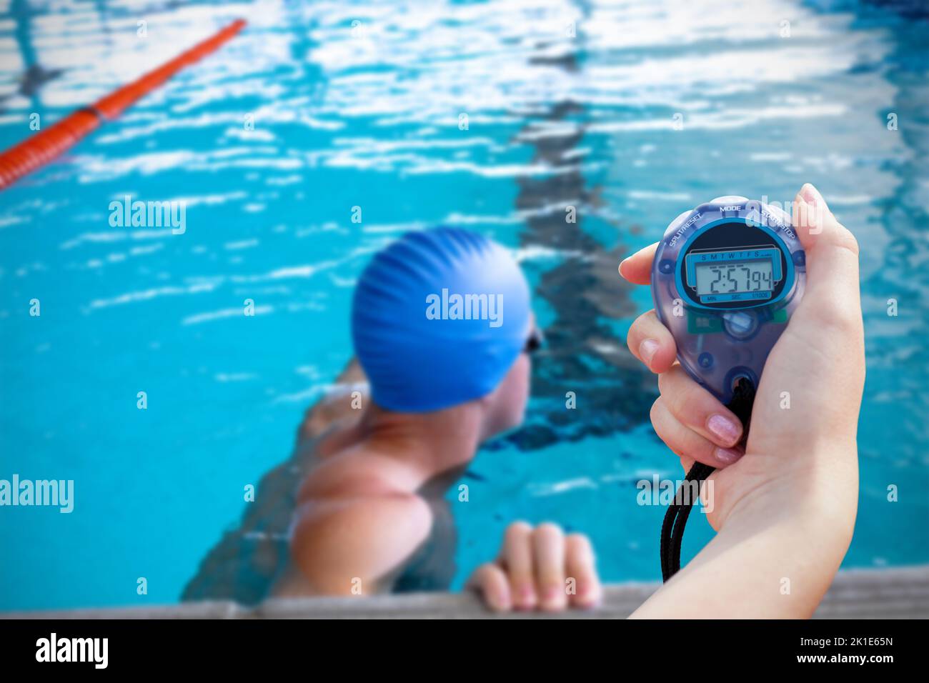 Close-up of a woman holding a chronometer to measure performance ...