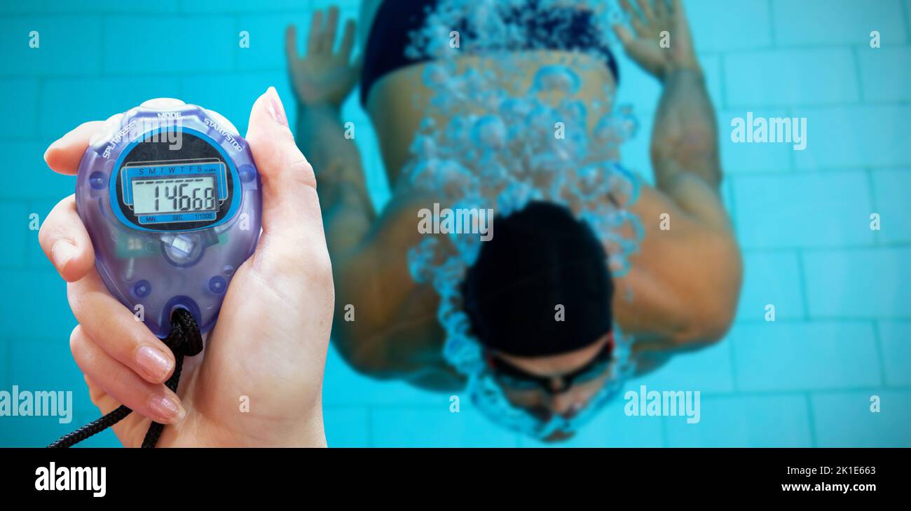 Close up of a hand holding a timer on a white background against ...