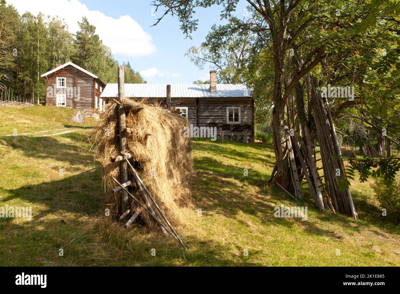 Hay-rack this side old wooden timber buildings. Equipment for farming ...