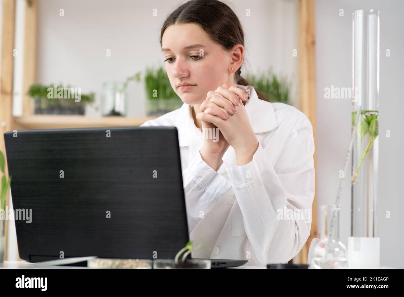 technology in science concept, woman scientist uses laptop while ...
