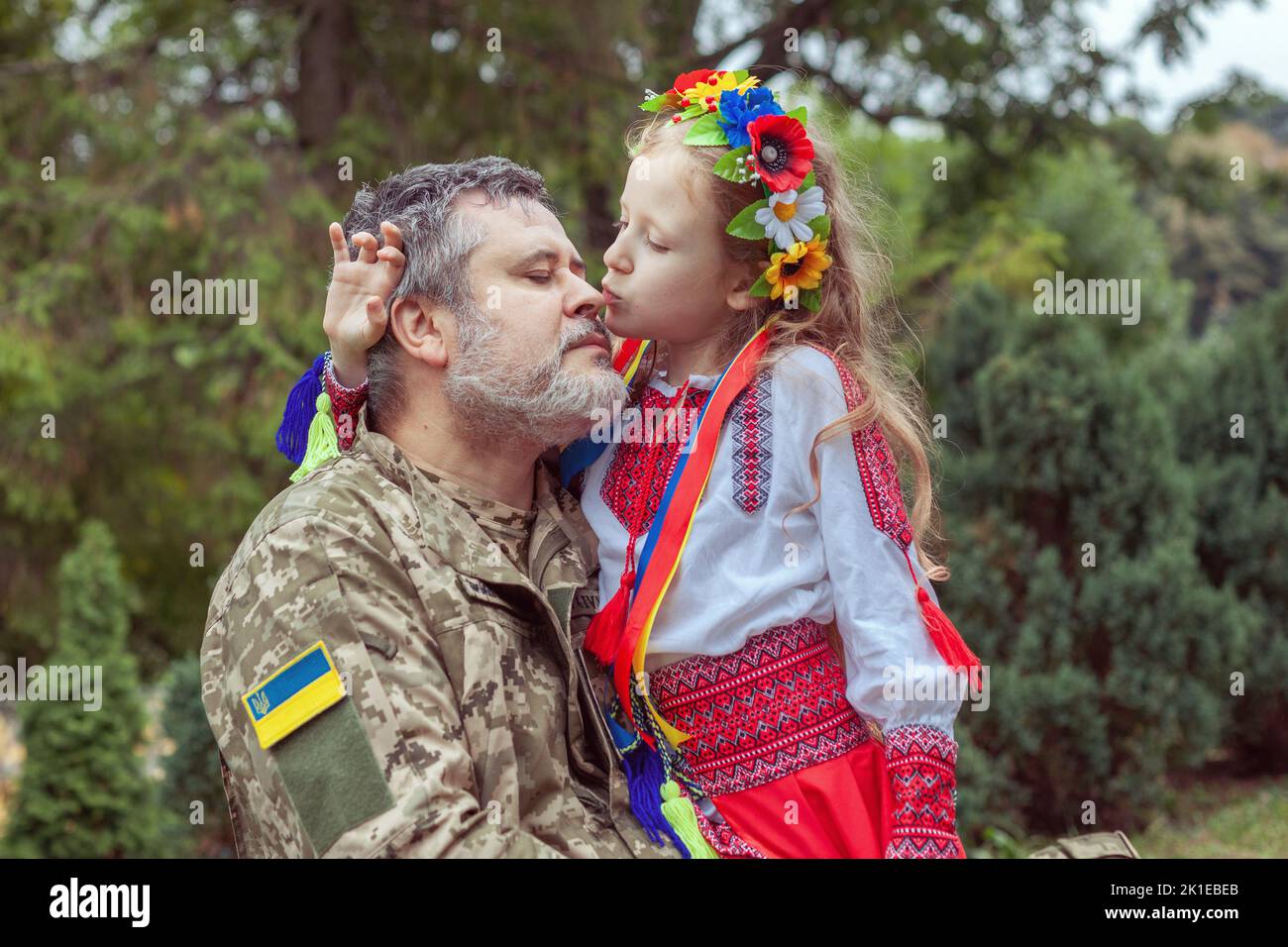 Portrait of a Ukrainian soldier with his little daughter. Long-awaited ...