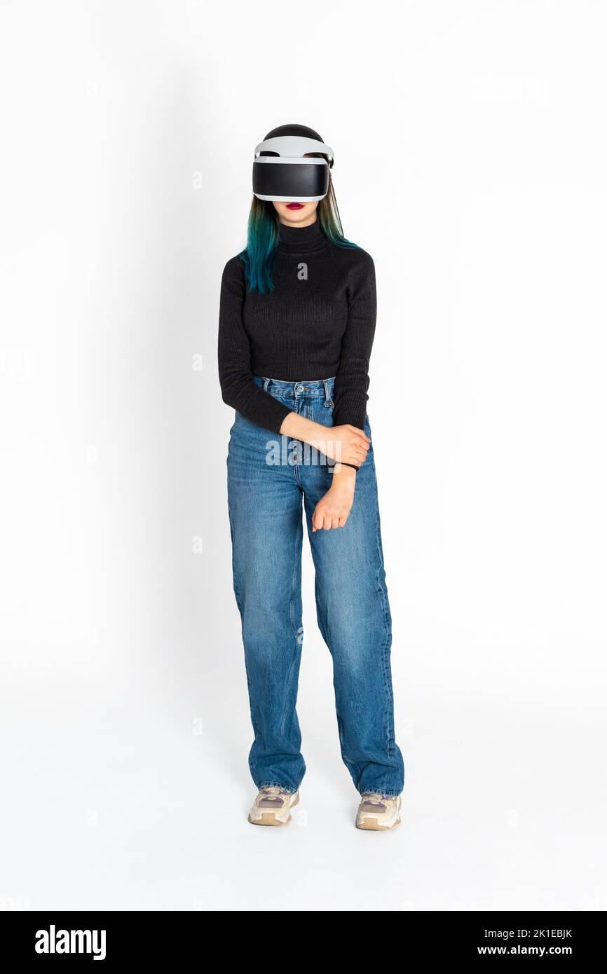 Virtual reality. A teenage girl with blue hair wearing virtual reality ...