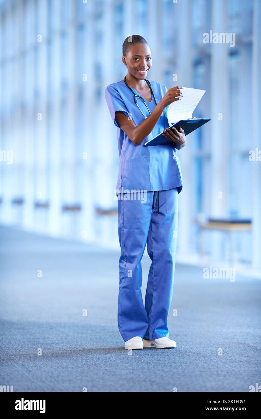Just checking the charts. Portrait of a young female doctor holding a ...