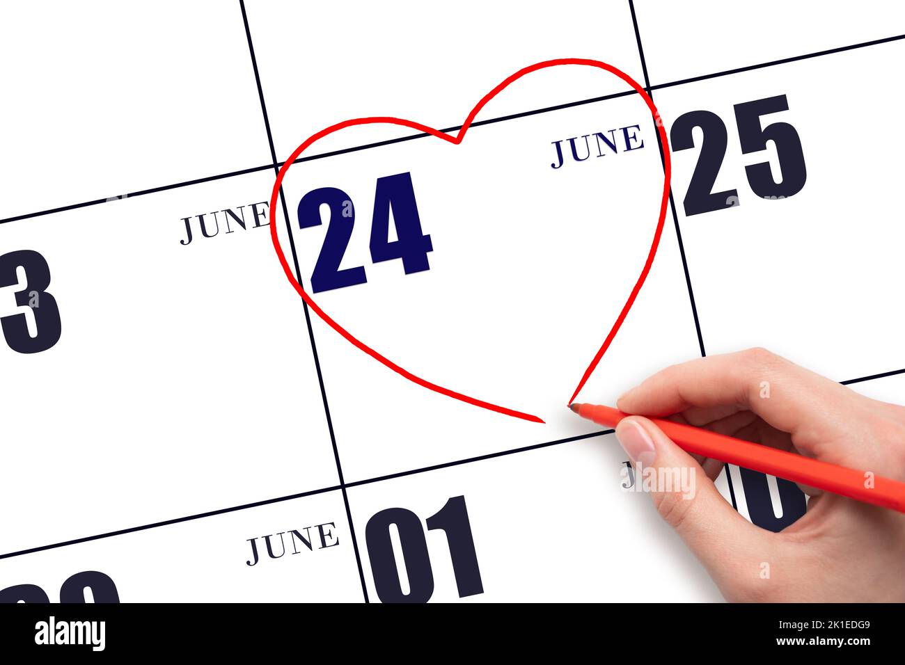 24th day of June. A woman's hand drawing a red heart shape on the ...