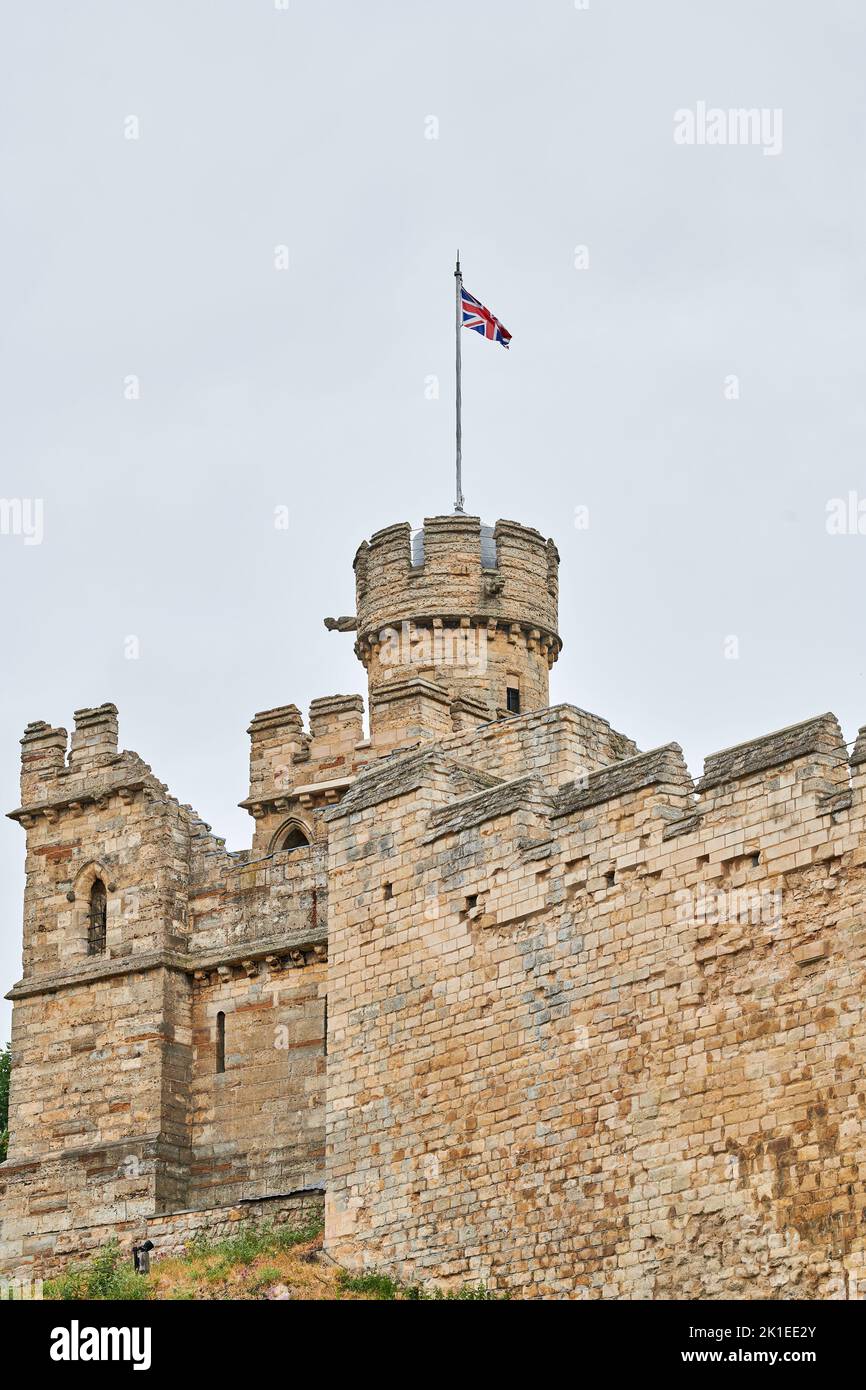 The union jack flag flutters above a turret at the norman castle in ...