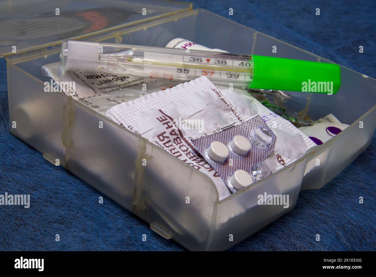 a first aid kit with a thermometer on a blue medical cloth Stock Photo ...