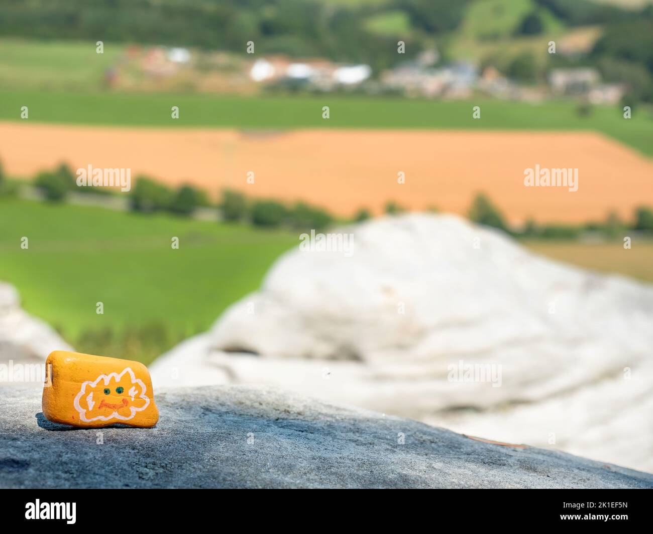 Laughing face painted on a small stone. Children game of painted ...