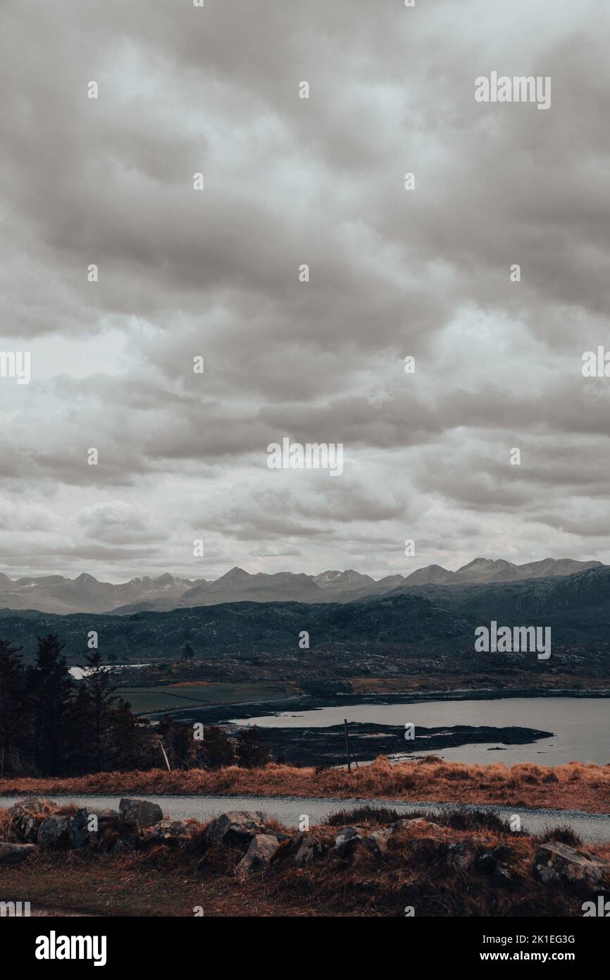 a vertical Beautiful shot across misty scottish highlands Stock Photo ...