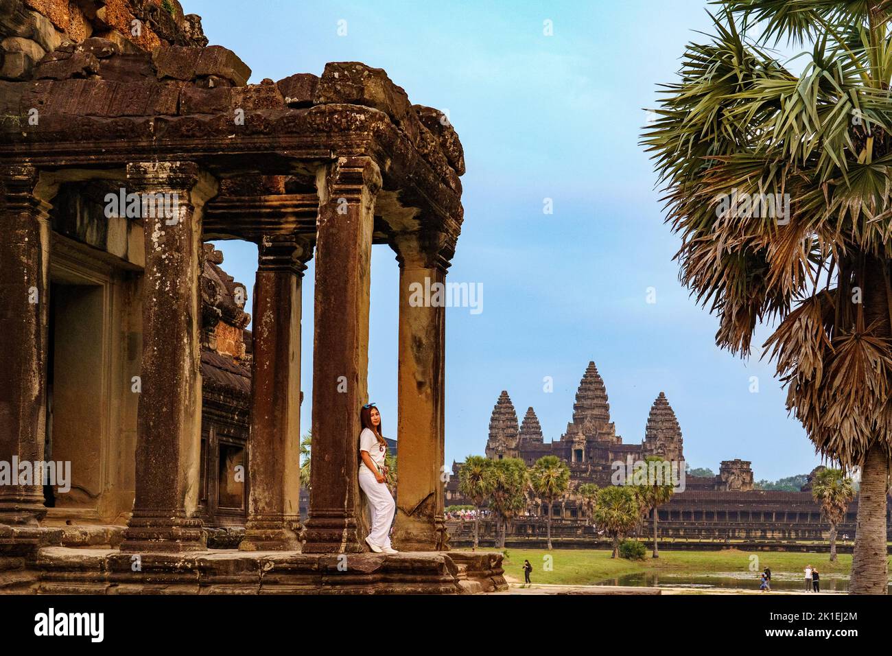 Cambodia. Siem Reap Province. A young woman pose at Angkor Wat (Temple ...