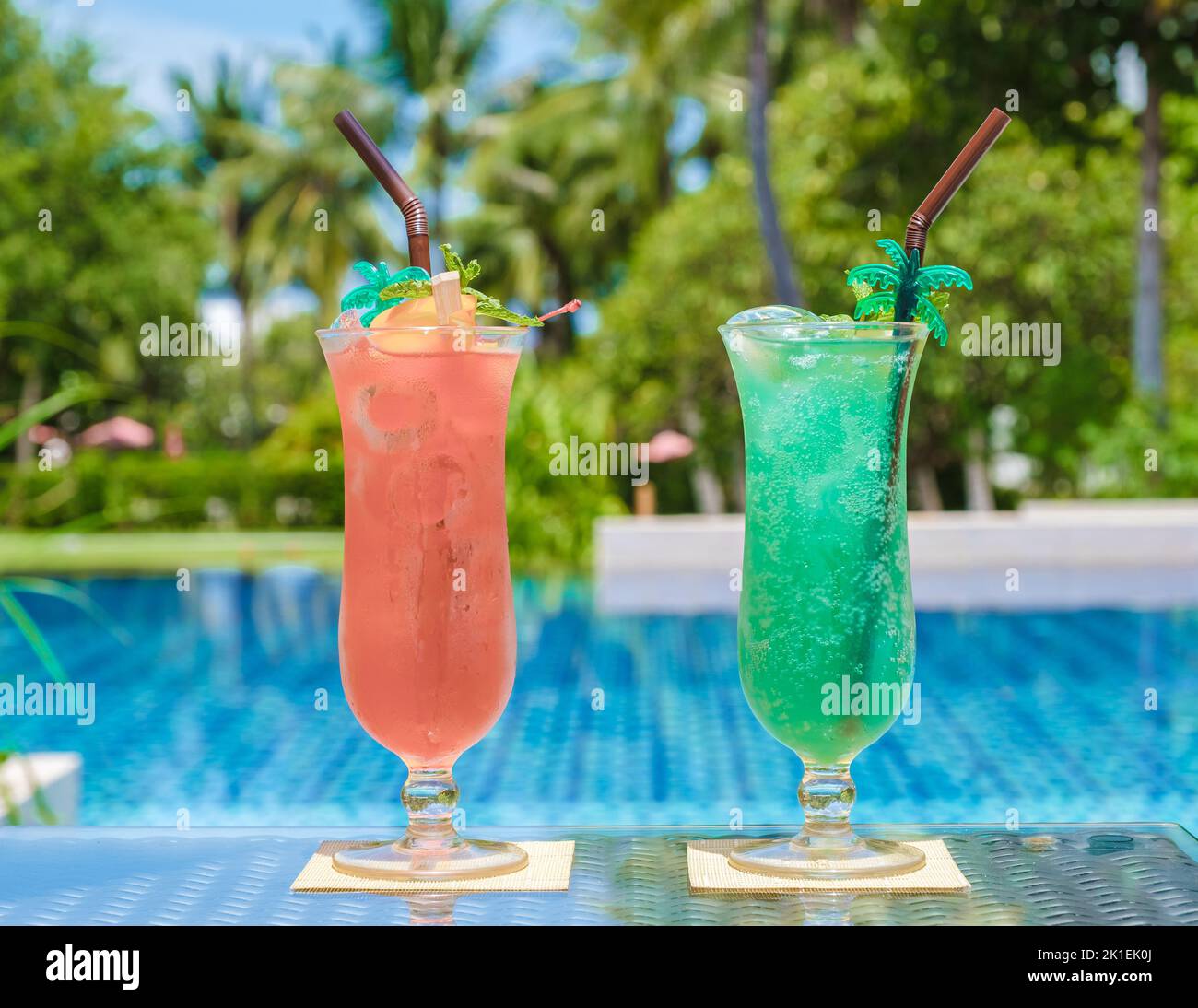 colorful mocktail at a pool bar, orange and green cocktail by the pool ...