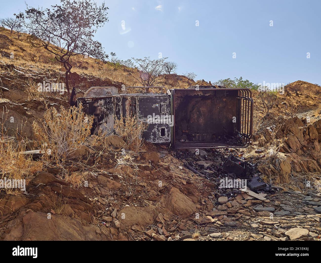burnt out car wreck lying on its side on steep Jan Joubert mountain ...
