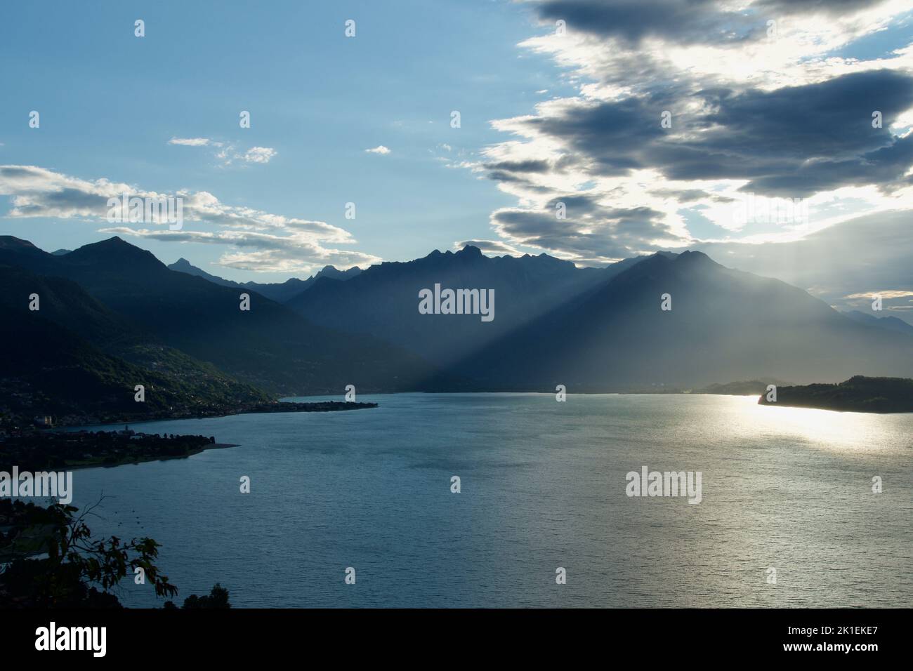 A scenic view of the mountains and Lake Como under blue cloudy sky in ...