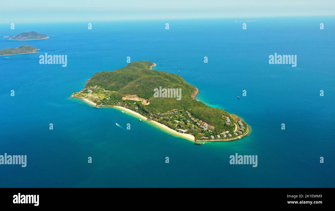 A bird's-eye view of a small island in the azure ocean Stock Photo - Alamy