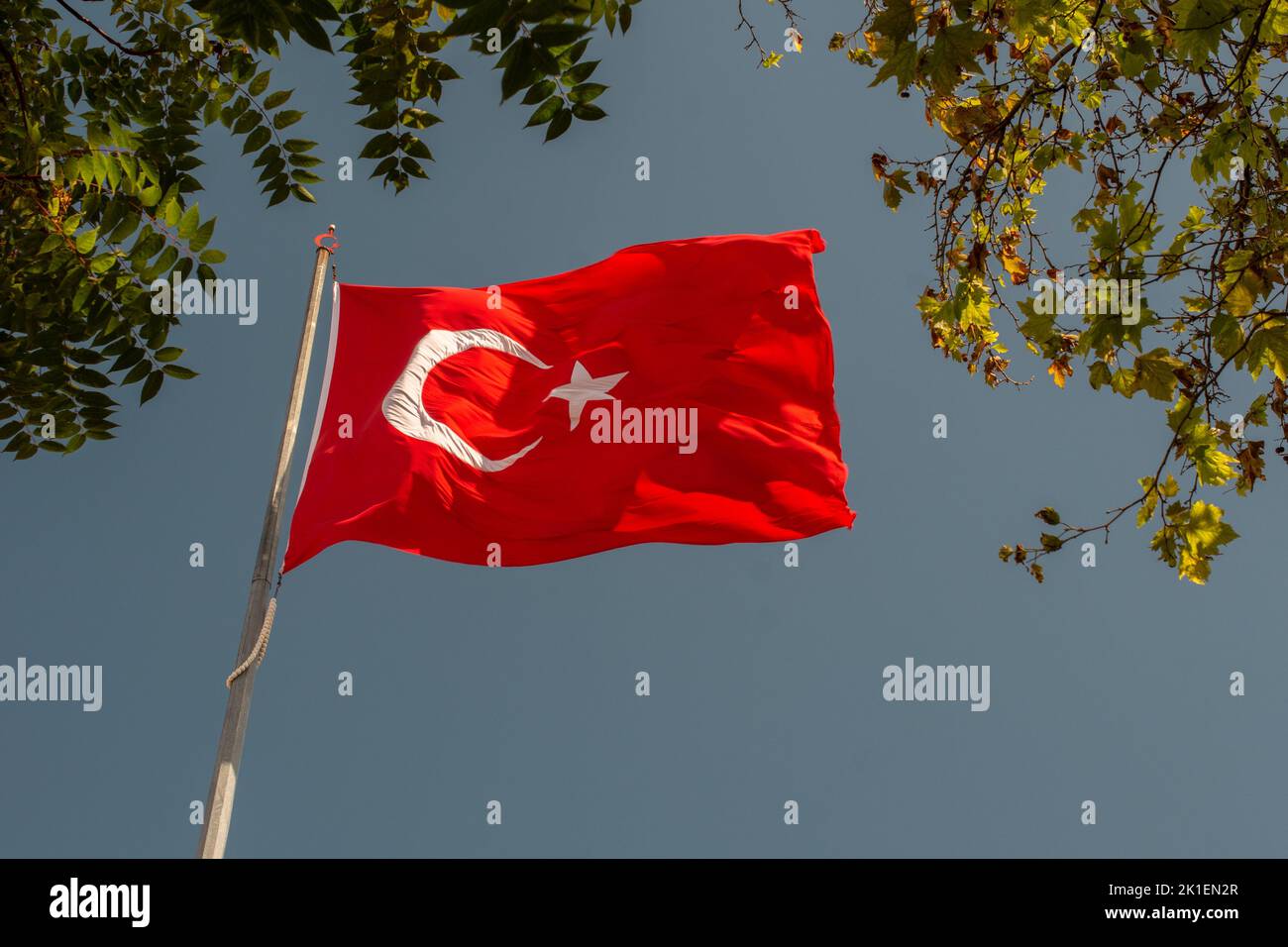 Turkish national flag with white star and moon on a pole in sky Stock ...