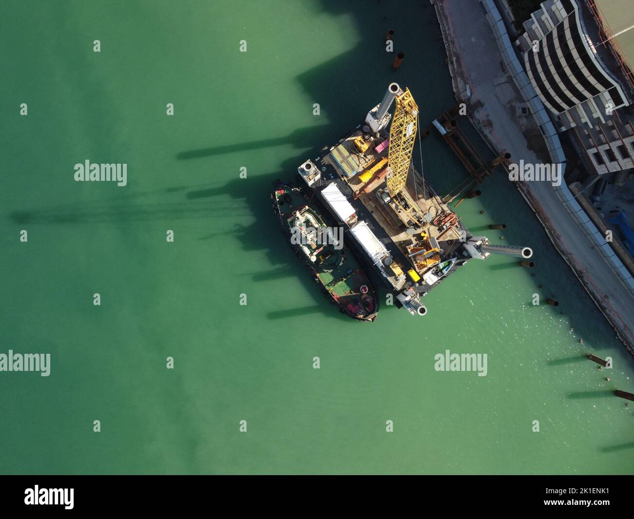 Floating crane dredging barges working on the construction of a marina. Aerial top view Stock ...