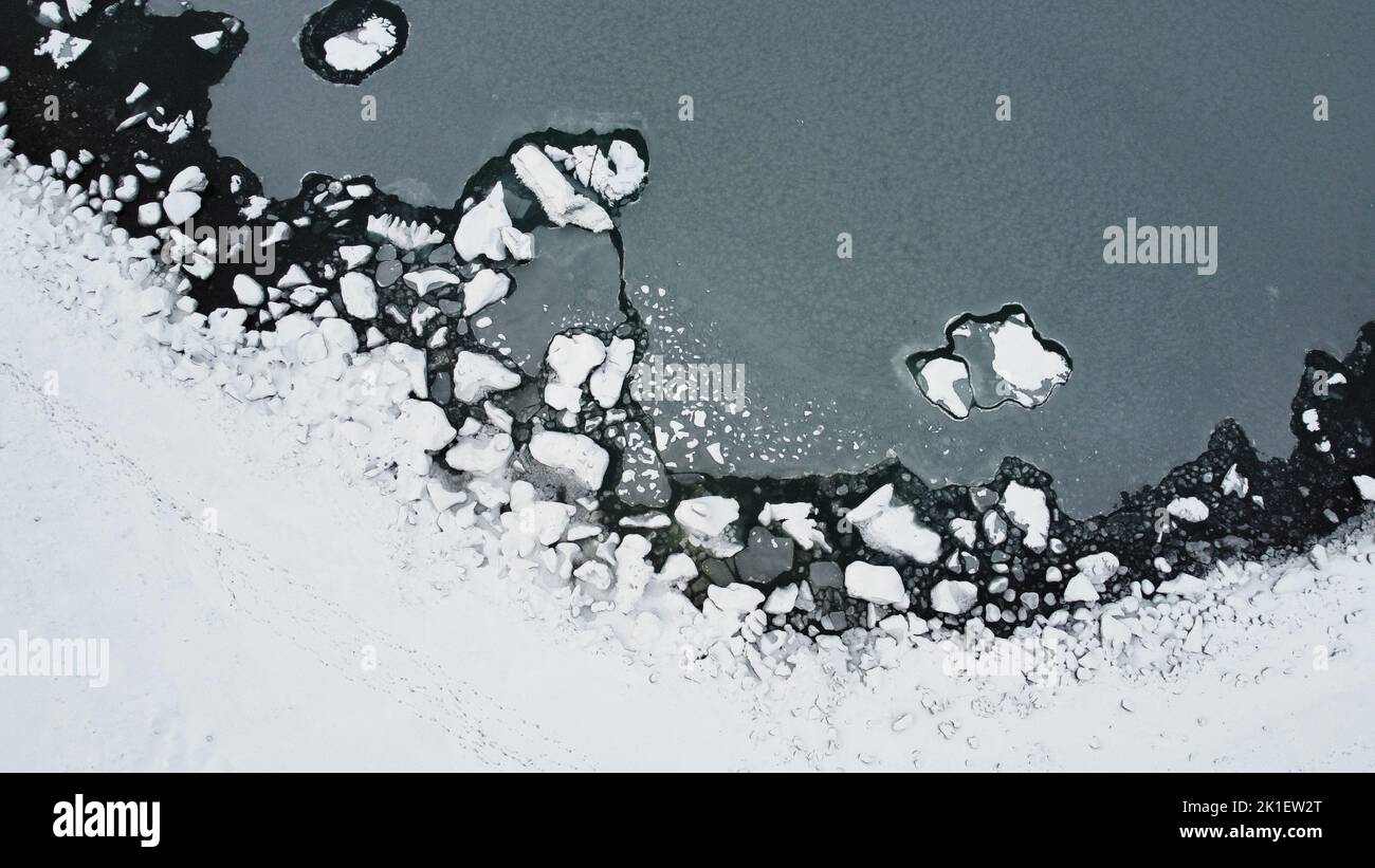 An aerial top view of ice on the beach near the water Stock Photo - Alamy