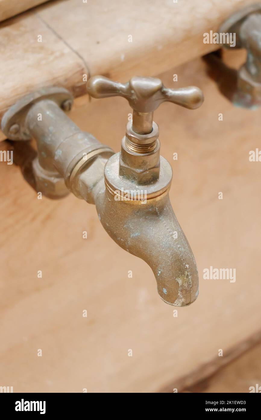 vintage brass water taps or faucets in old English house washroom or ...