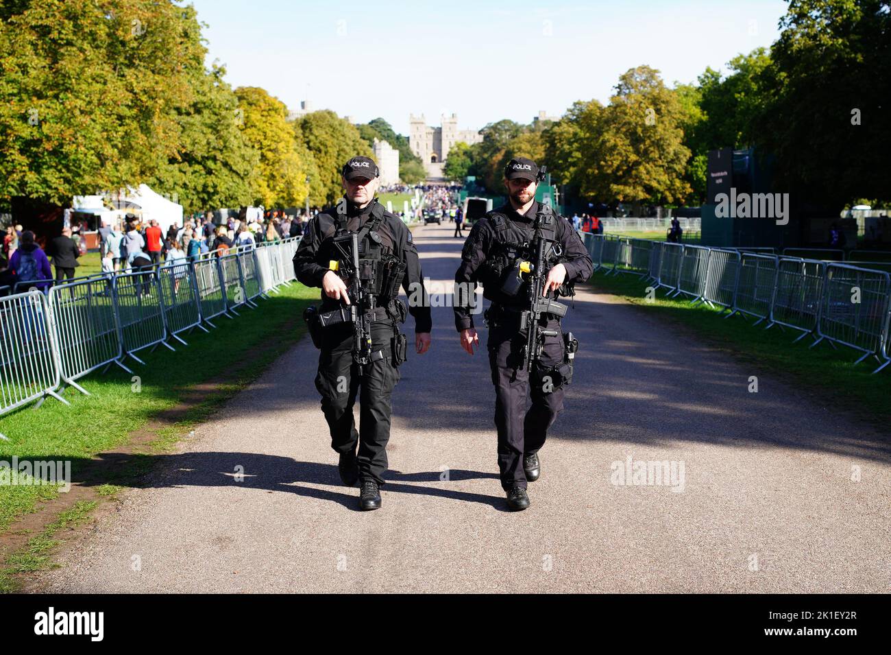 Armed police officers on patrol near to a police screening area on the ...
